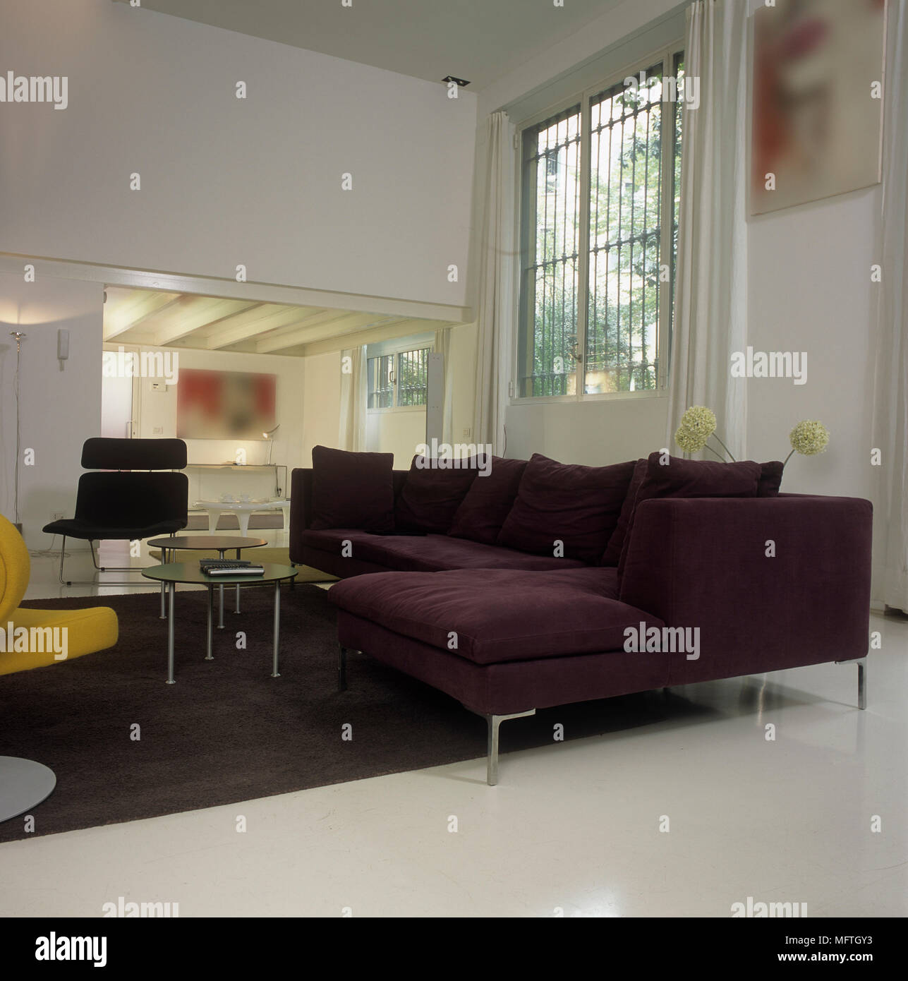 Upholstered sofa in open plan room Stock Photo - Alamy