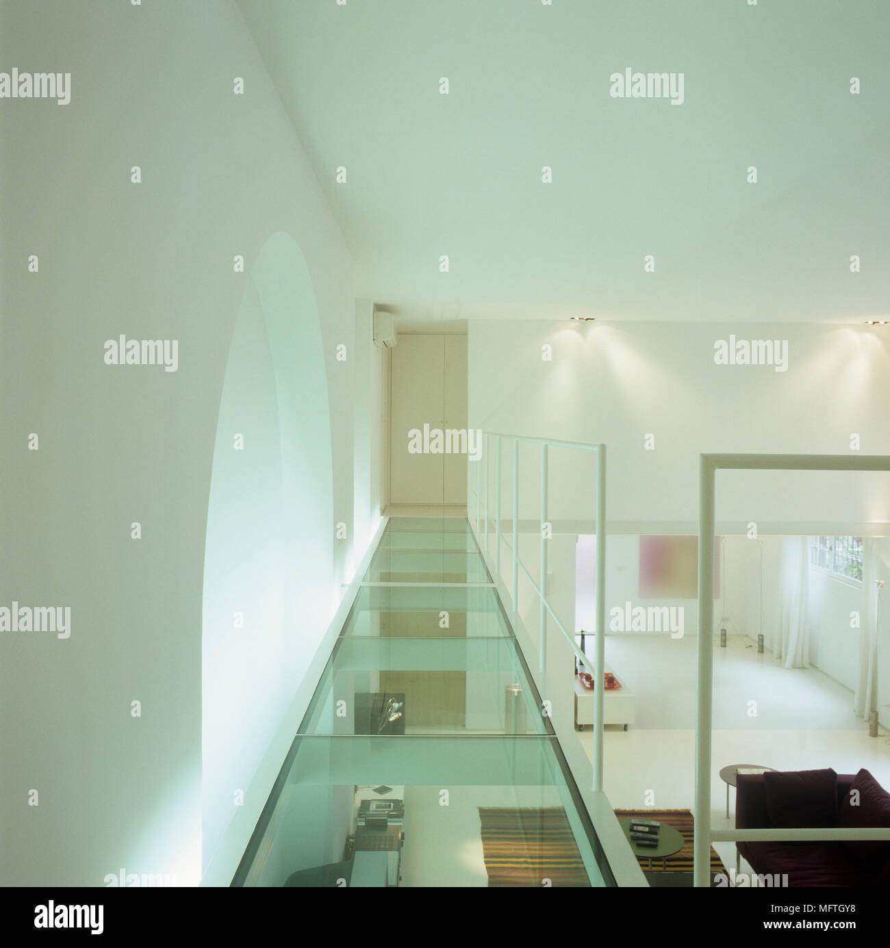 Glass floored landing area with open plan room below Stock Photo - Alamy