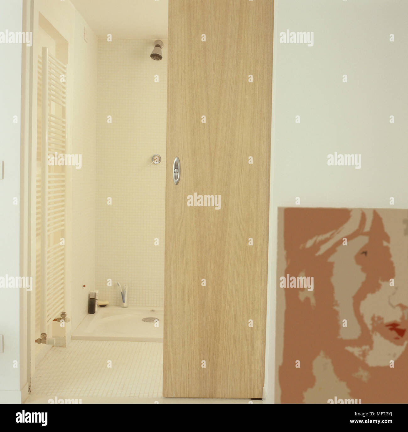 Wooden door partly open with bathroom beyond Stock Photo - Alamy