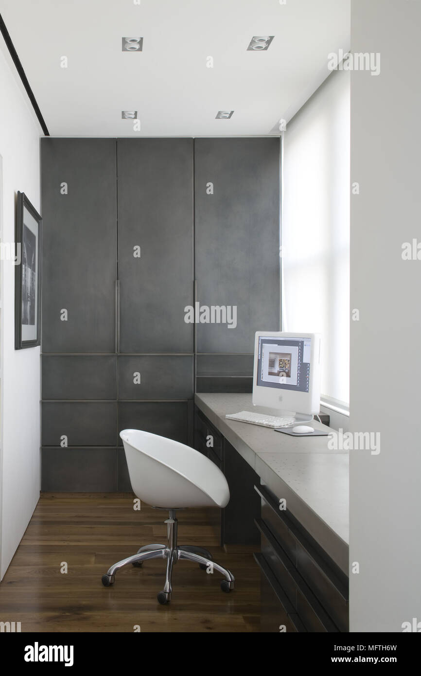 Computer on built in table unit in modern home office Stock Photo - Alamy