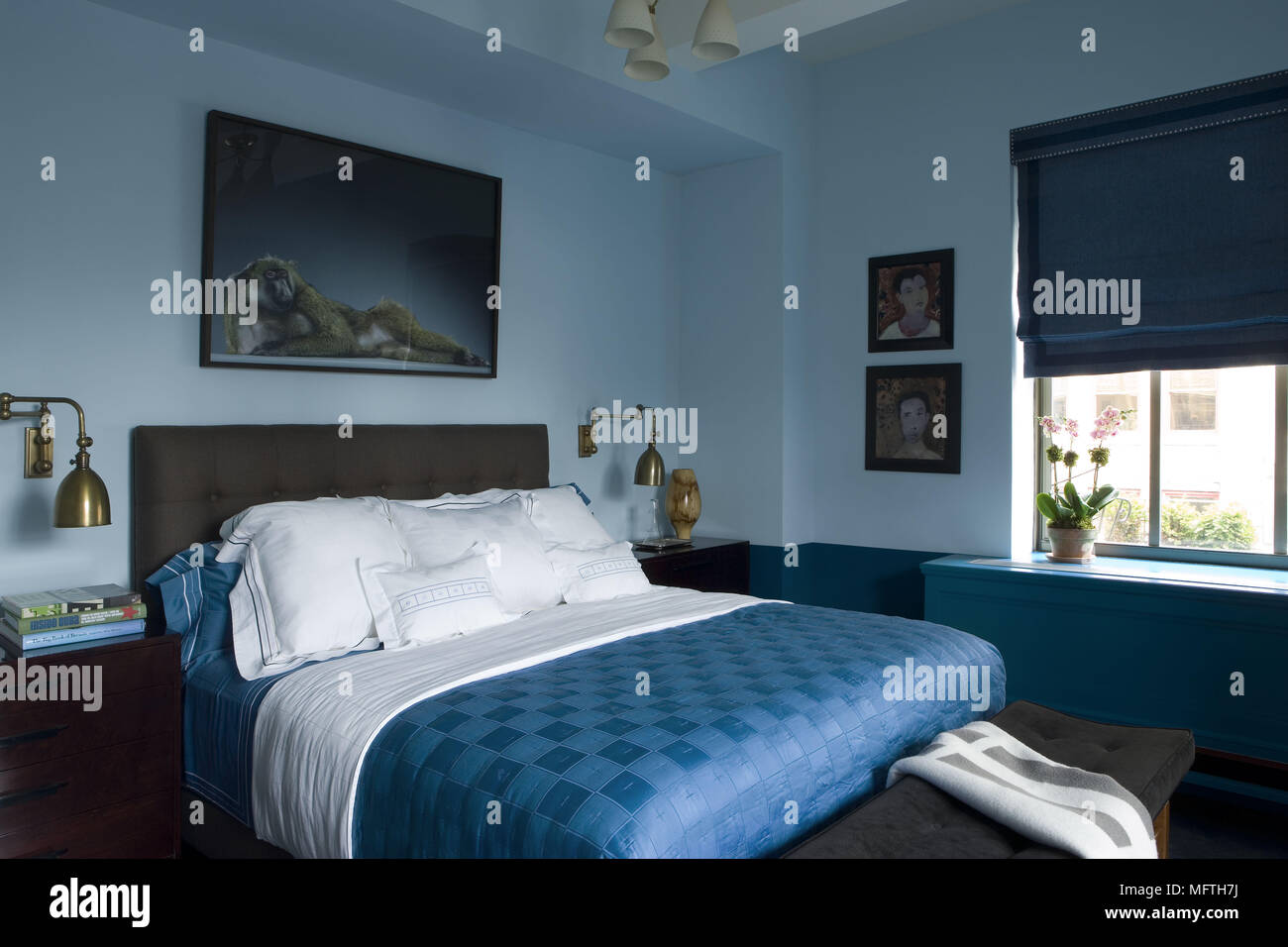 Double bed with upholstered headboard in traditional style blue bedroom ...