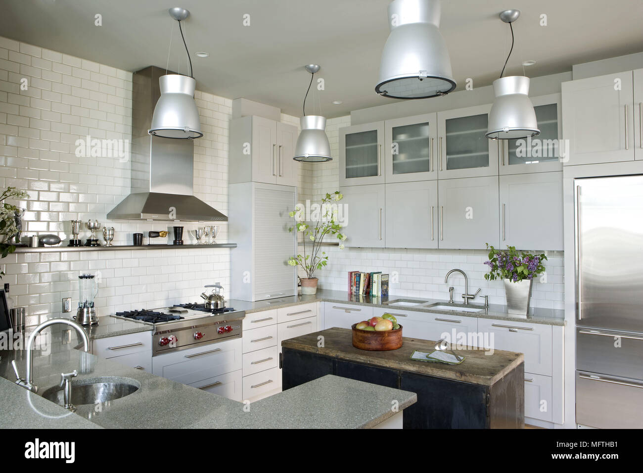 Modern kitchen with white fitted units and tiled wall Stock Photo - Alamy