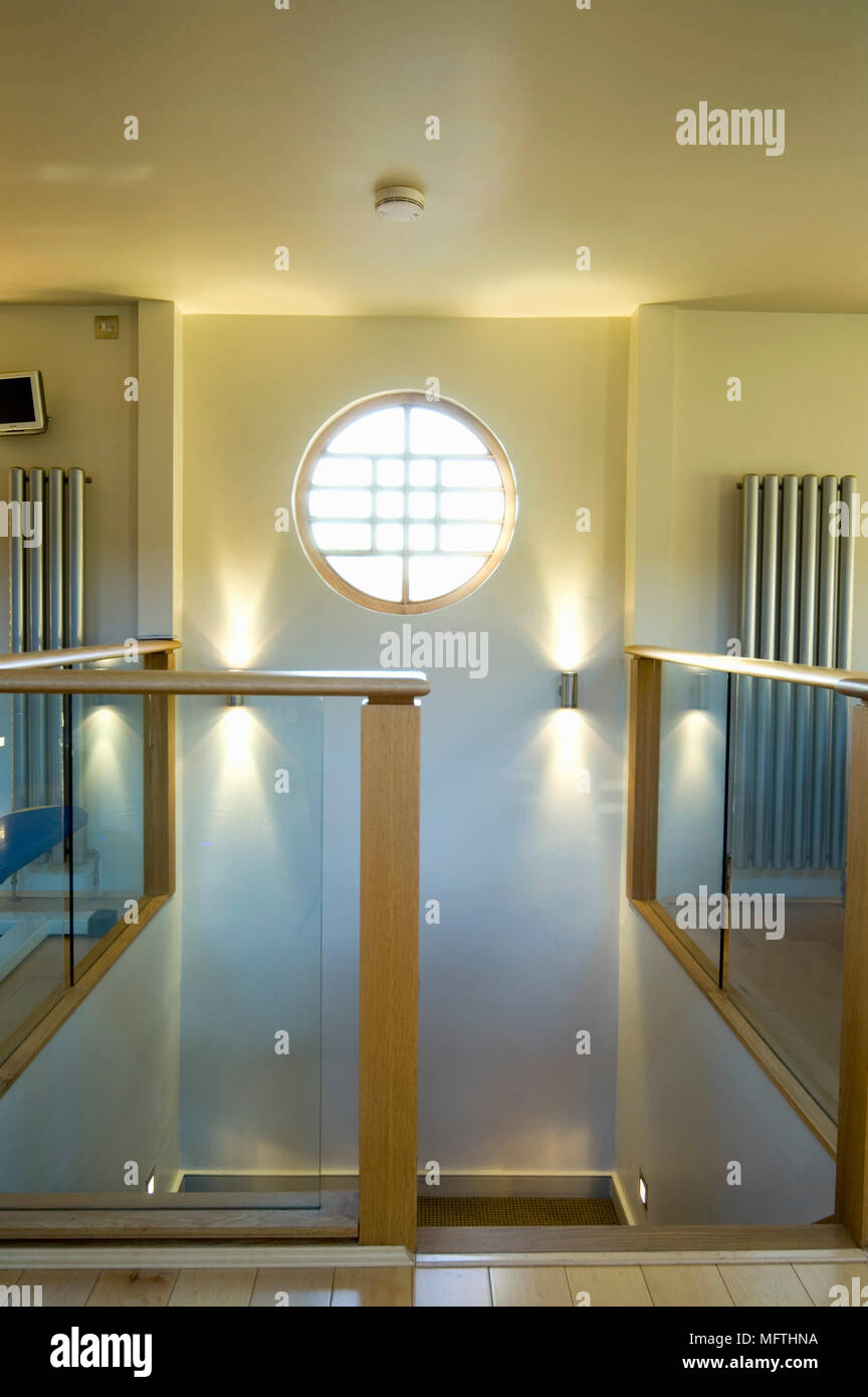 Detail of staircase with glass banister and circular window Stock Photo ...