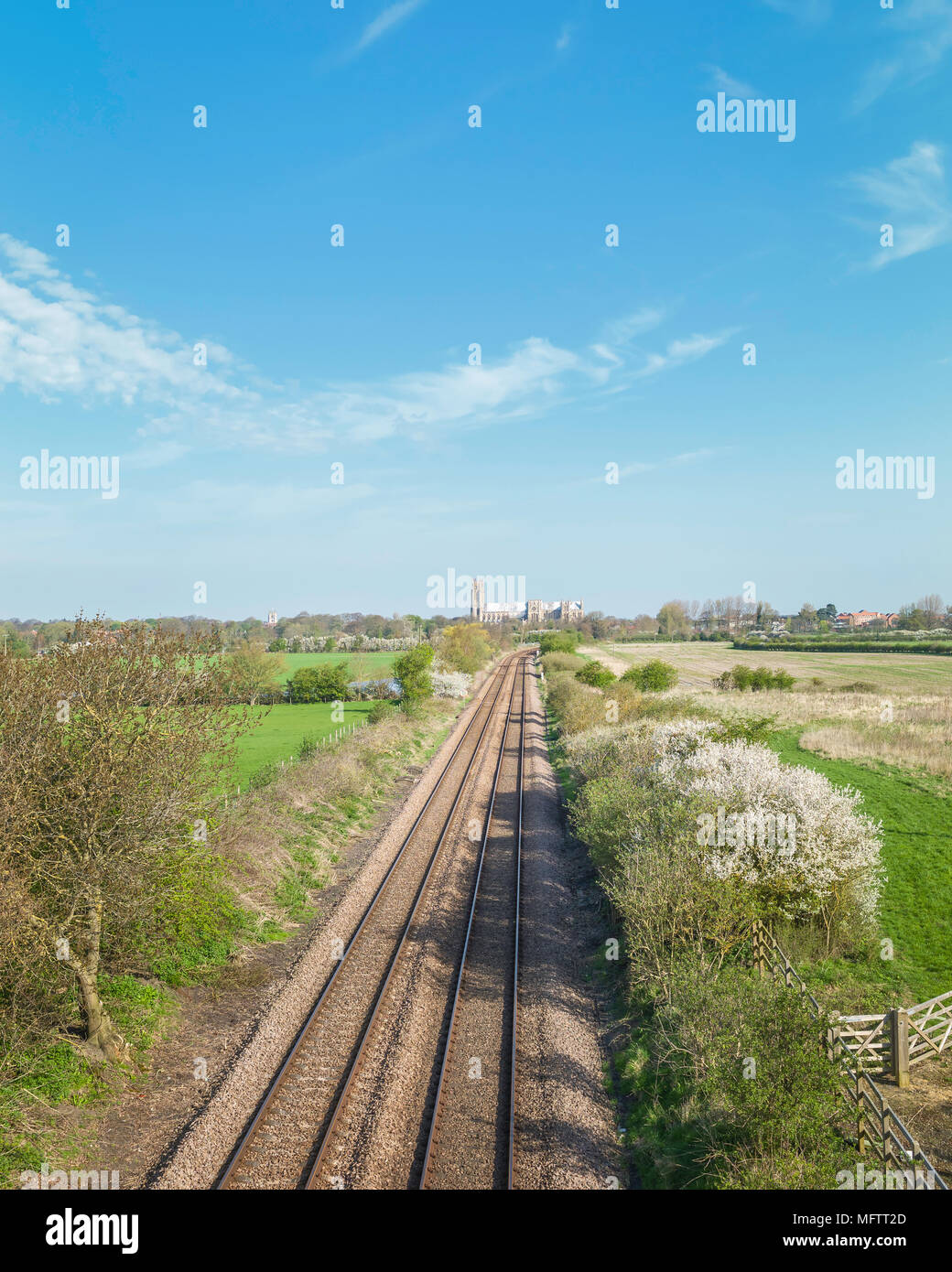 Railway track leading to the ancient minster and flanked by fields and ...