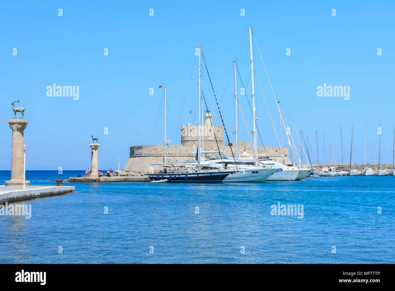 Ancient statue of a deer and a medieval lighthouse at the port of ...