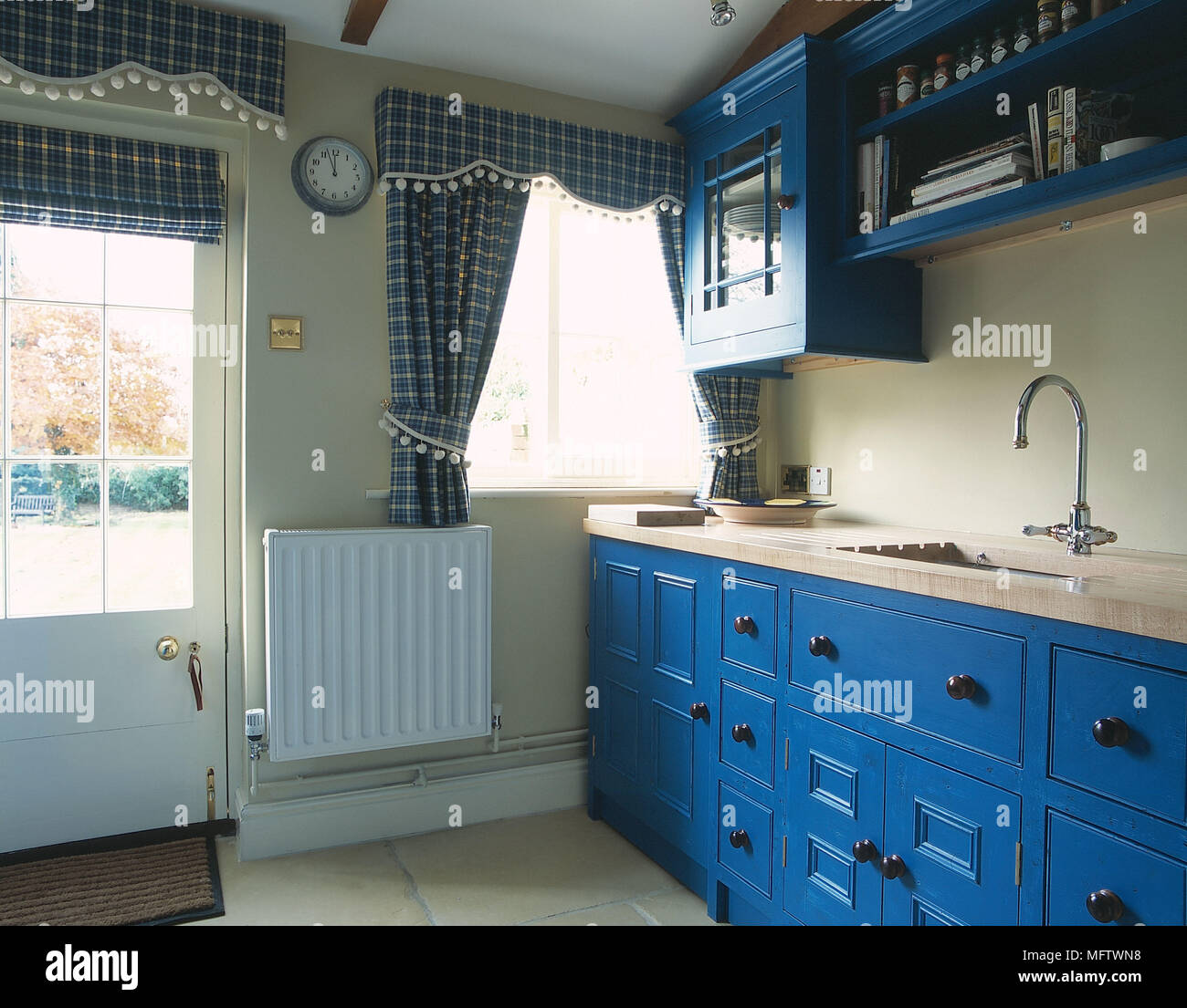 Country style kitchen with blue painted cupboards Stock Photo - Alamy