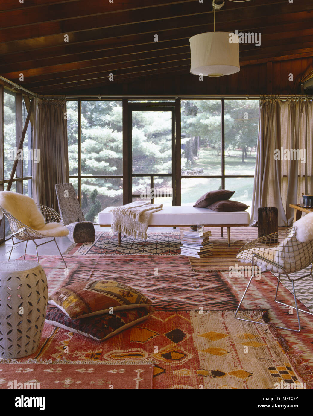 Sitting room with modern furniture floor to ceiling windows and a ...