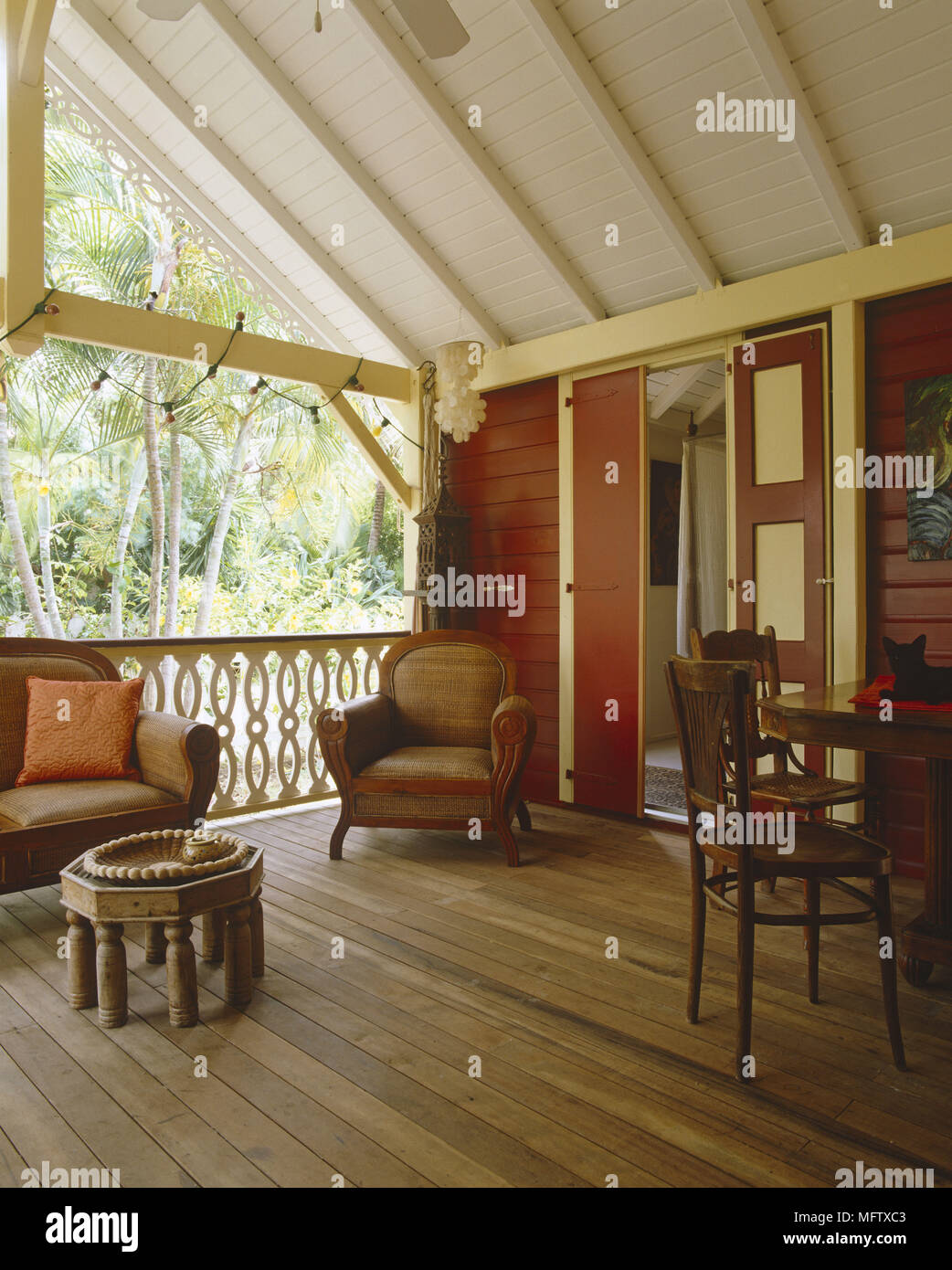 Veranda with wooden flooring and a selection of wooden furniture with ...