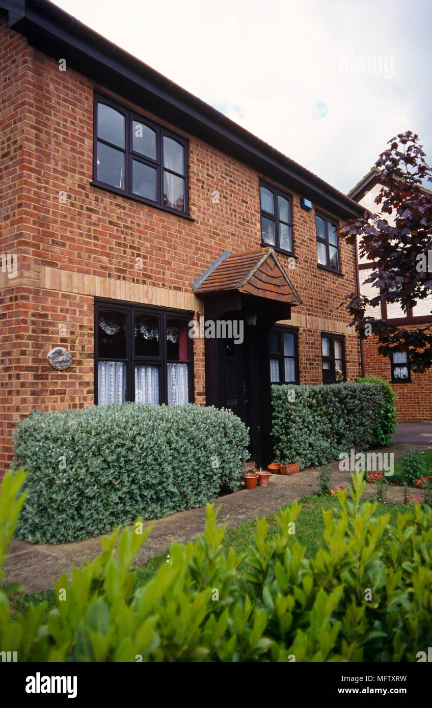 New build red brick housing and front garden Stock Photo - Alamy
