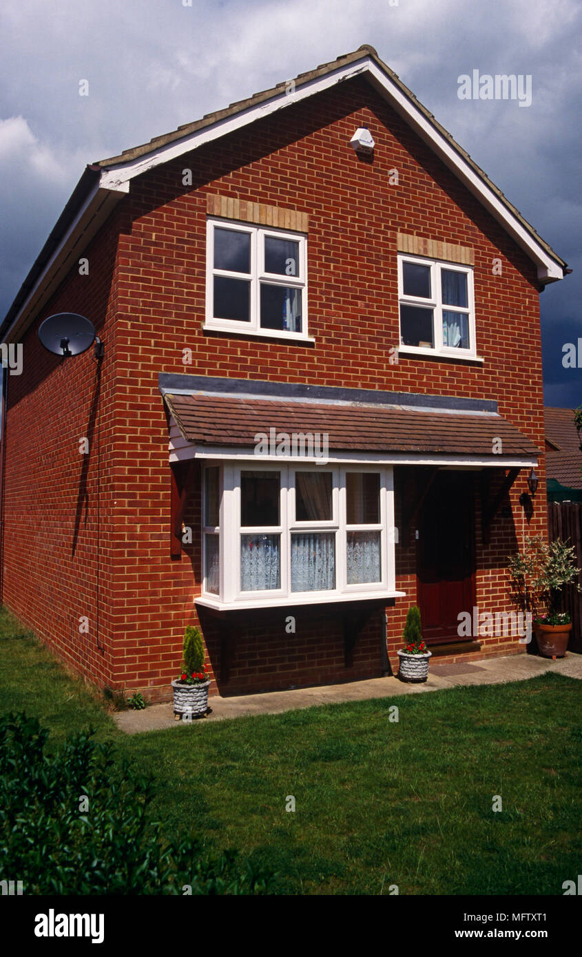 New build red brick housing and front garden Stock Photo - Alamy