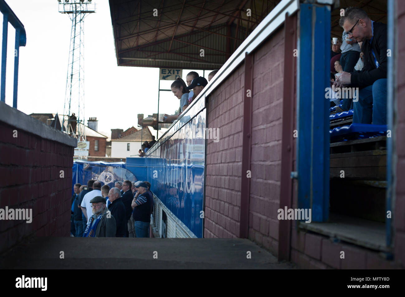 Fans in the main stand and enclosure watching the pre-match warm-up ...
