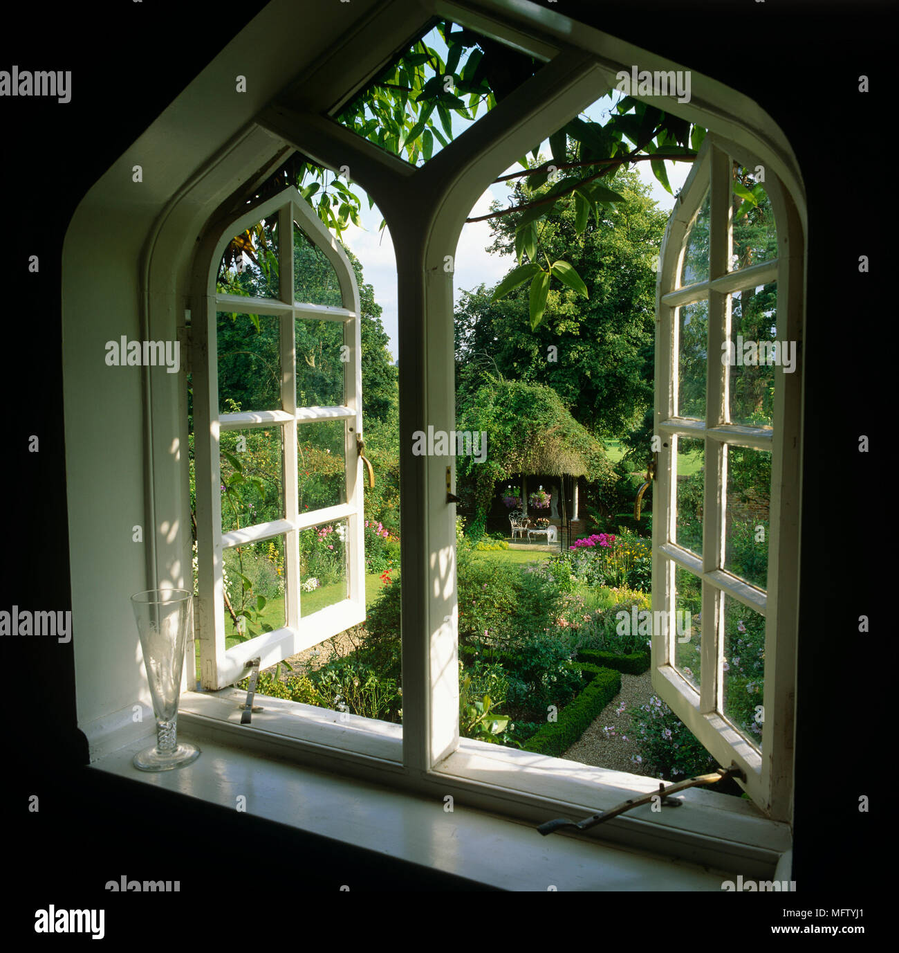 View from arched window to garden beyond Stock Photo - Alamy