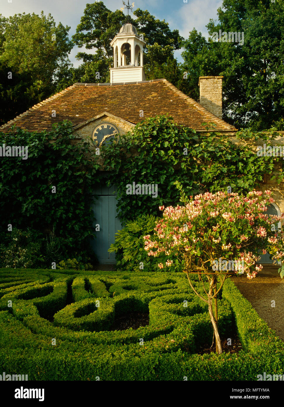 Garden with clock house and maze, Haseley Court, Oxfordshire, UK Stock ...