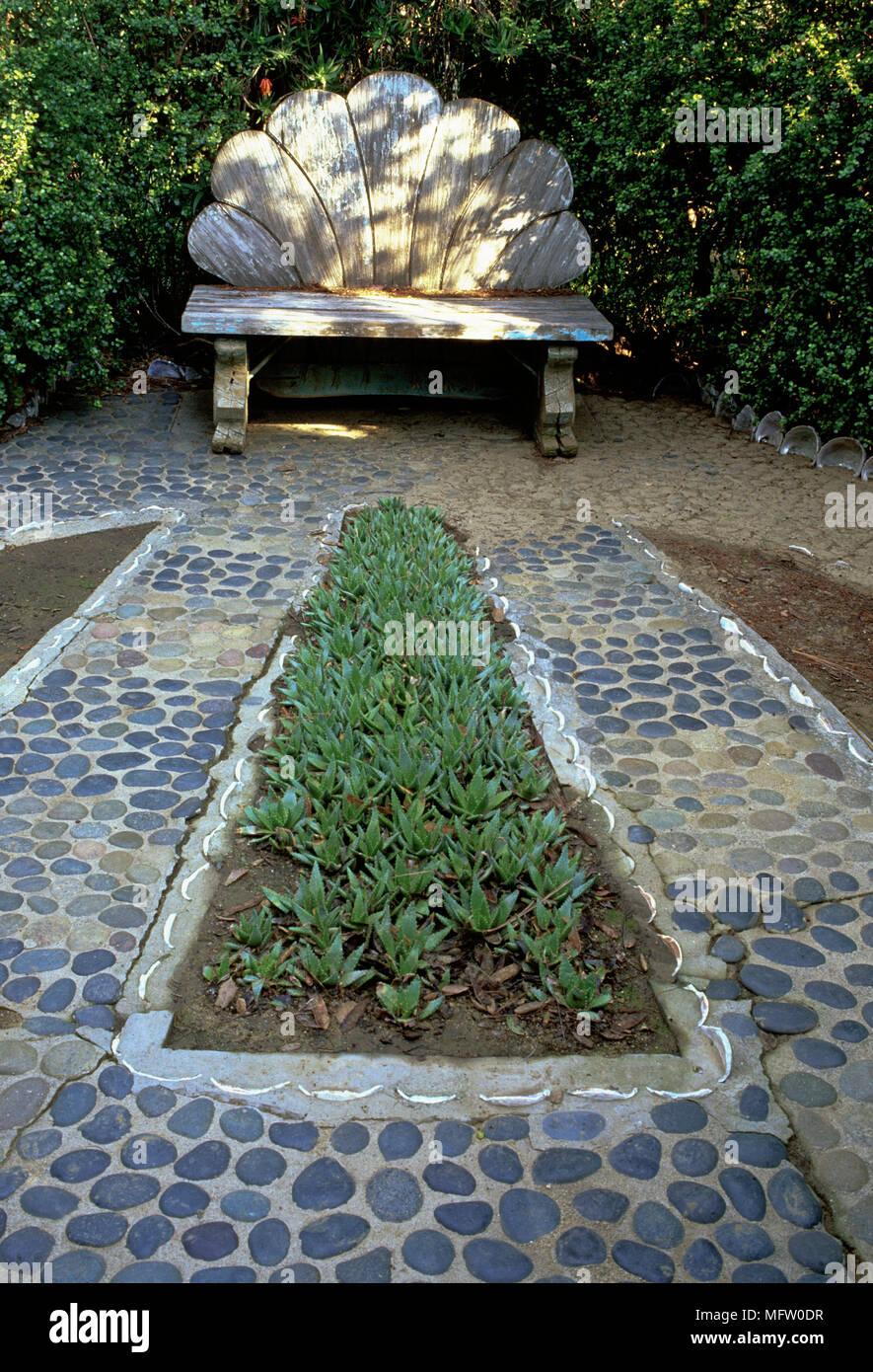 Stone bench seat in paved area of garden Stock Photo - Alamy