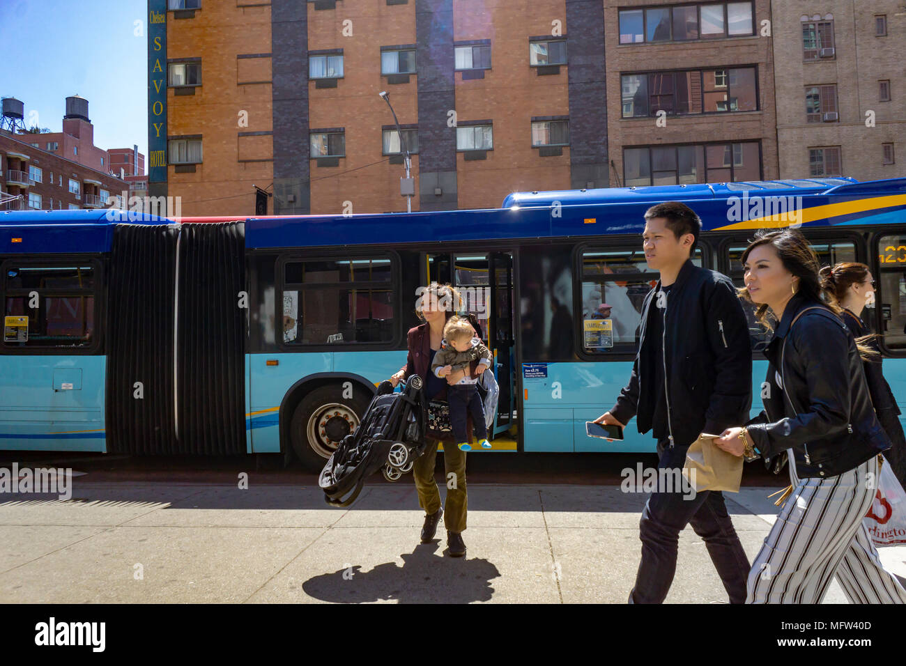 Passengers board and depart a Select Bus Service bus on the M23 route ...