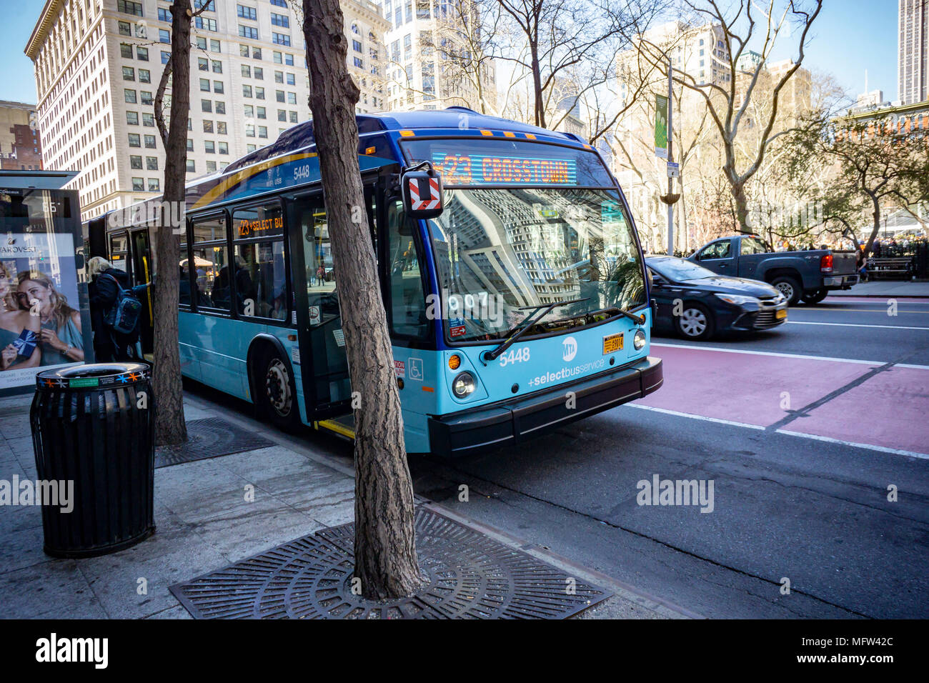 Passengers board and depart a Select Bus Service bus on the M23 route ...