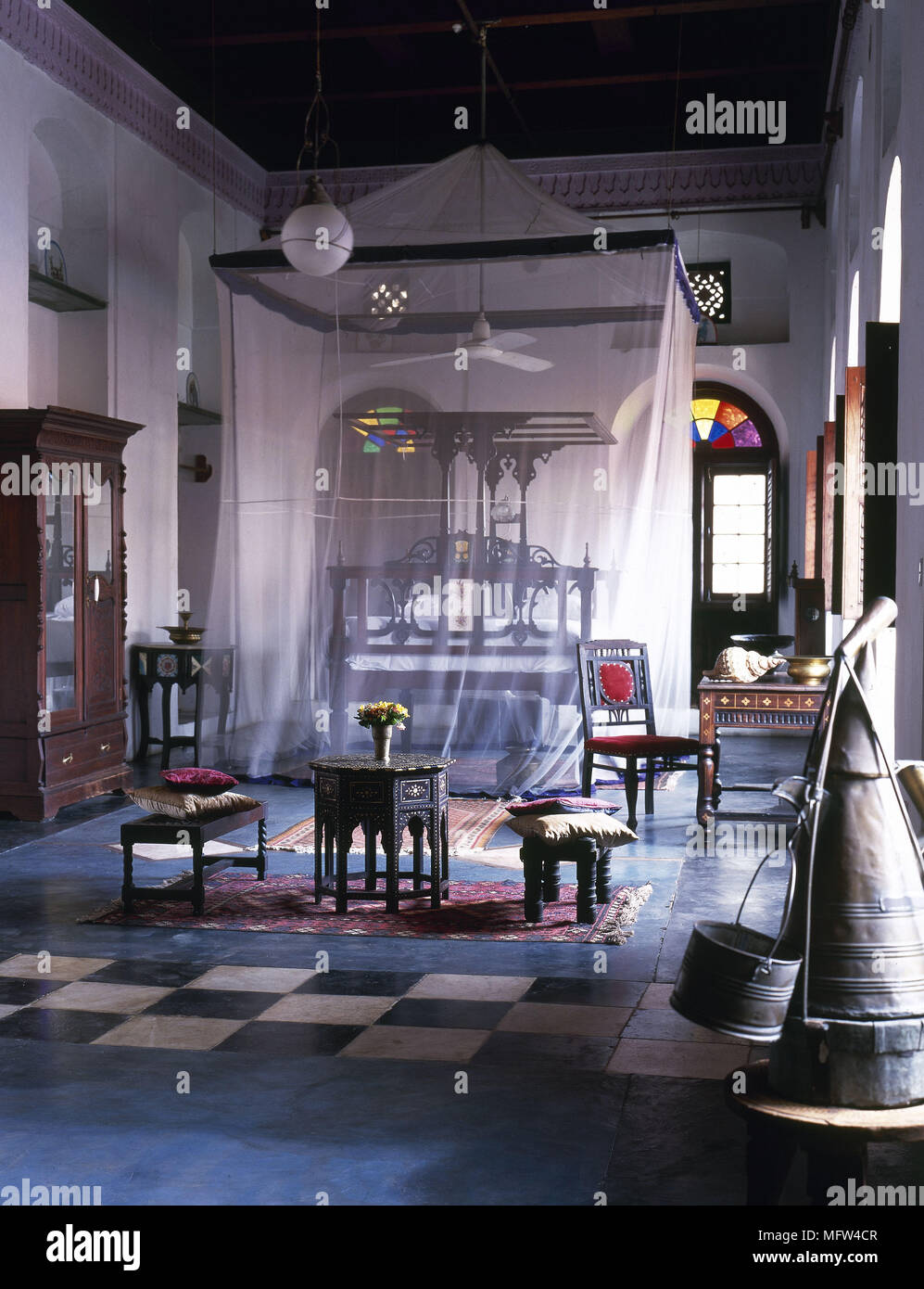 Arabic style bedroom with carved wooden bed with mosquito net Stock ...