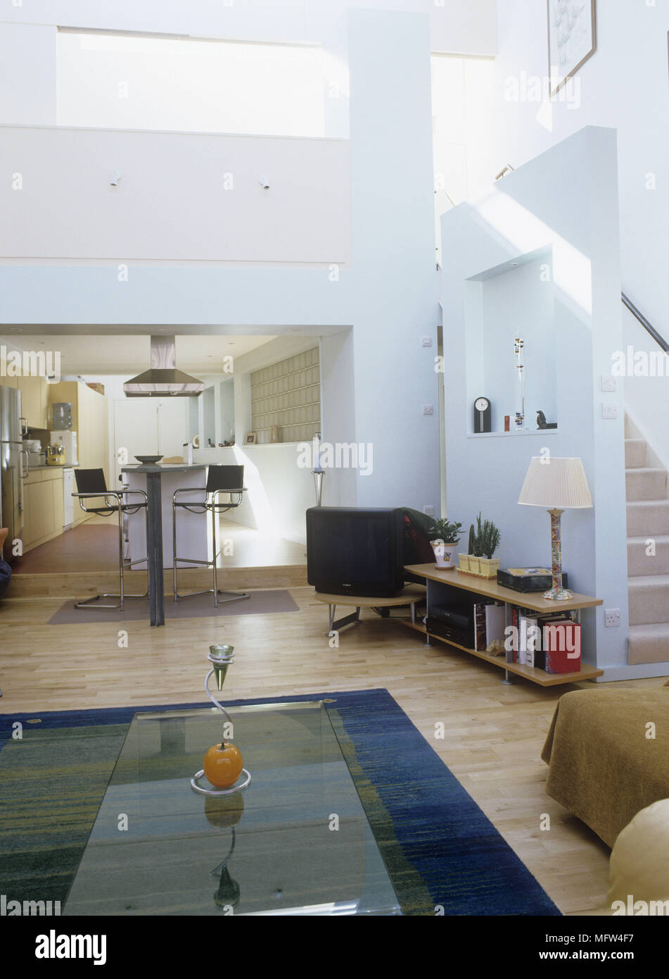 Contemporary open plan room with sitting and kitchen areas Stock Photo ...