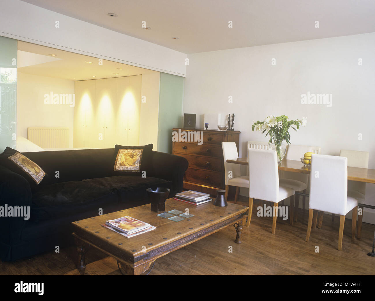 Contemporary open plan sitting room with dining table and chairs Stock ...