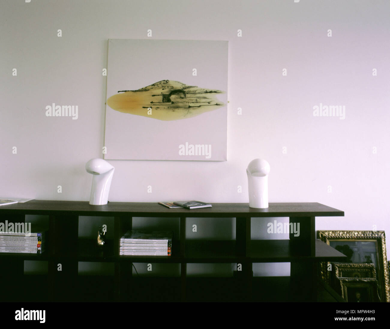 Detail of an abstract painting over open black shelving Stock Photo - Alamy