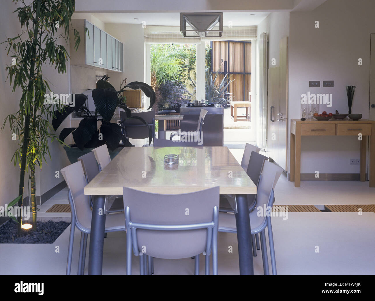 Dining table and chairs in opened plan room Stock Photo - Alamy