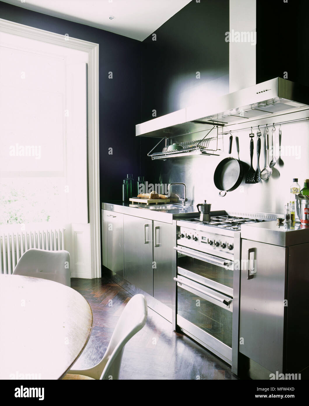 Modern kitchen dining area stainless steel units oven table chairs ...