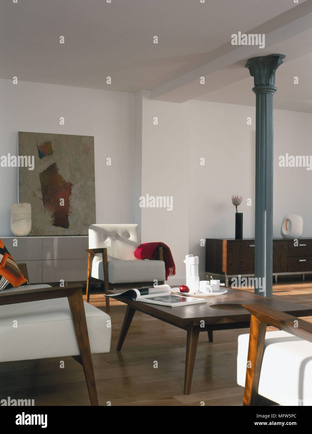 A modern sitting room with contemporary table and chairs next to a ...