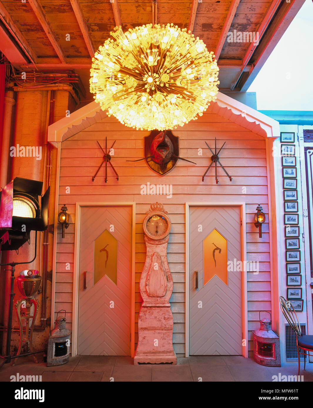 Details of a large oval lamp suspended above a painted grandfather ...