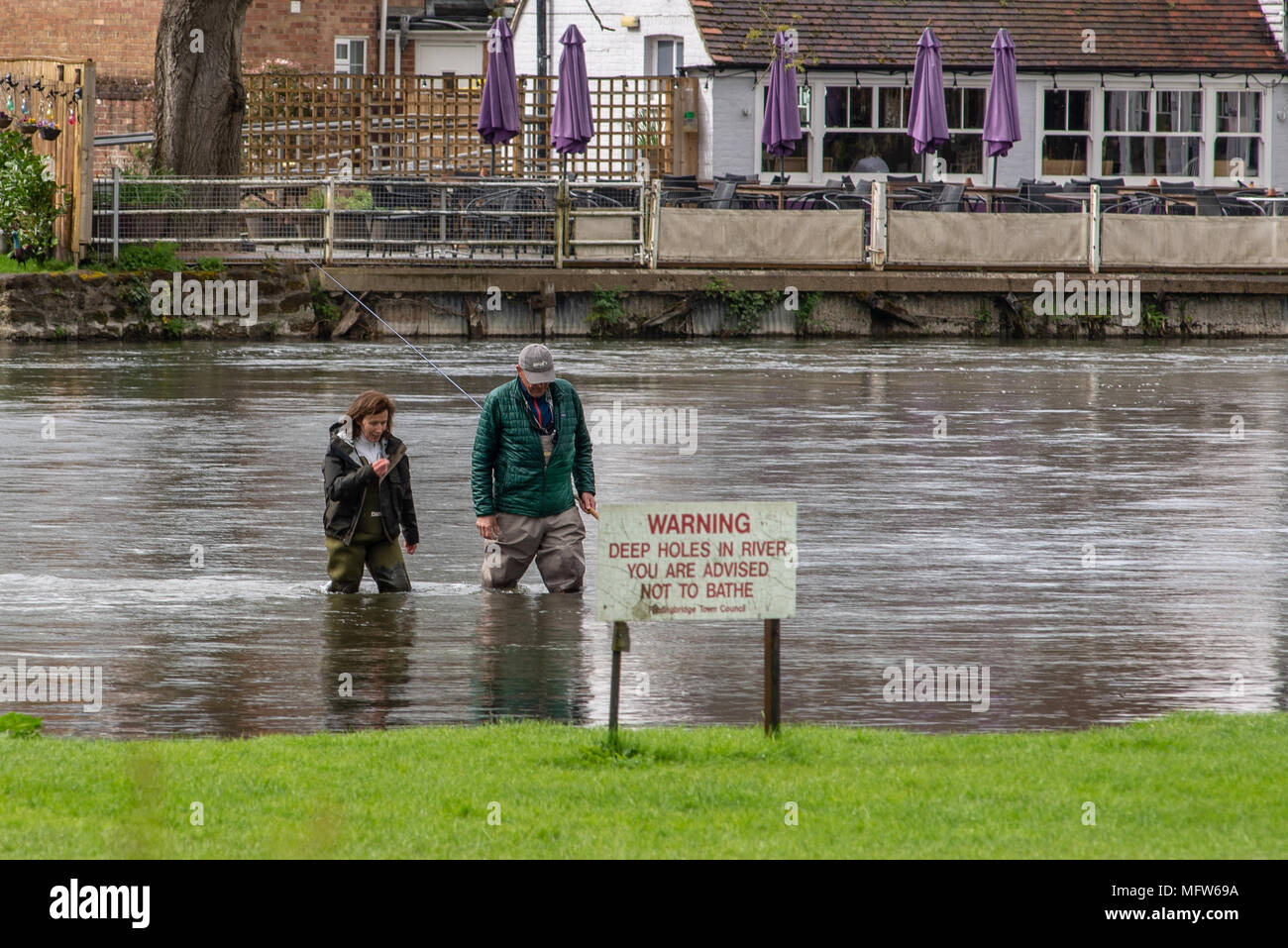 Couple wading in the river while fishing in the Avon, Fordingbridge ...