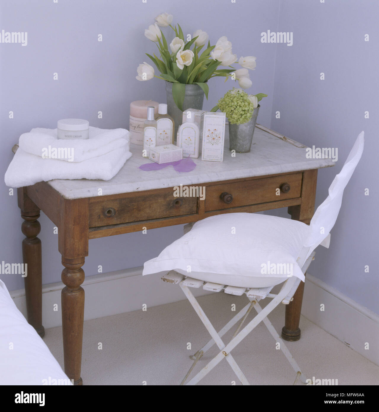 A detail of a country bedroom showing a wooden wash stand table with ...