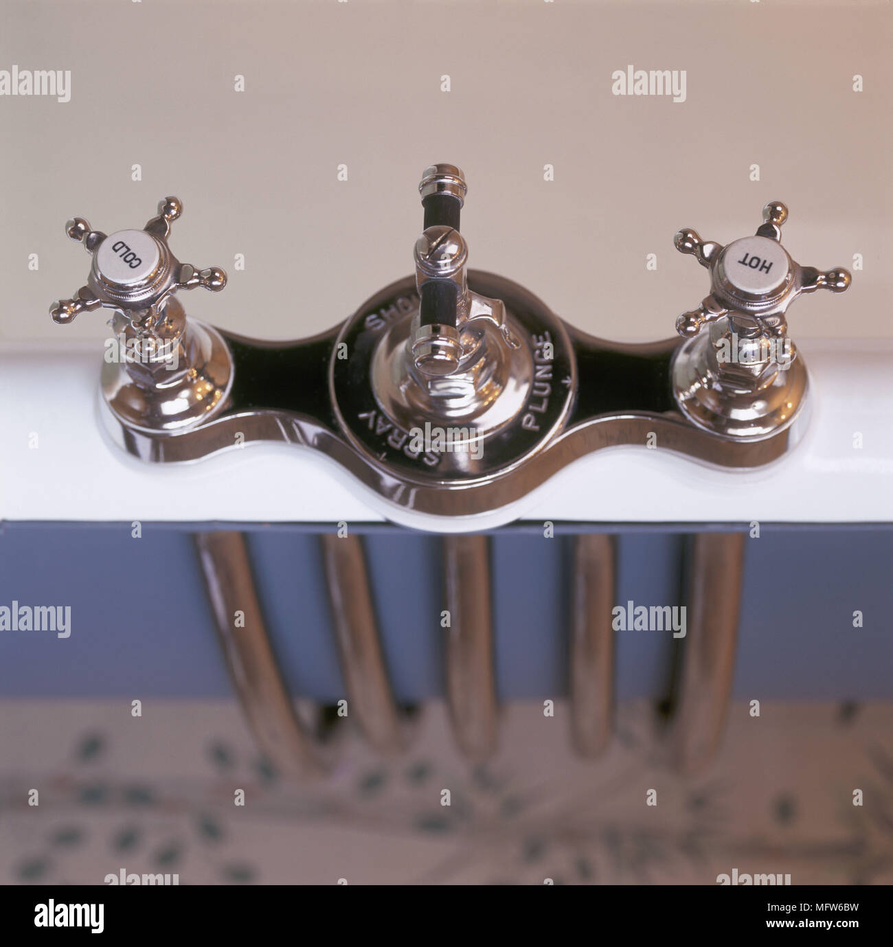 A detail of a pair of old fashioned traditional shower tap fittings ...