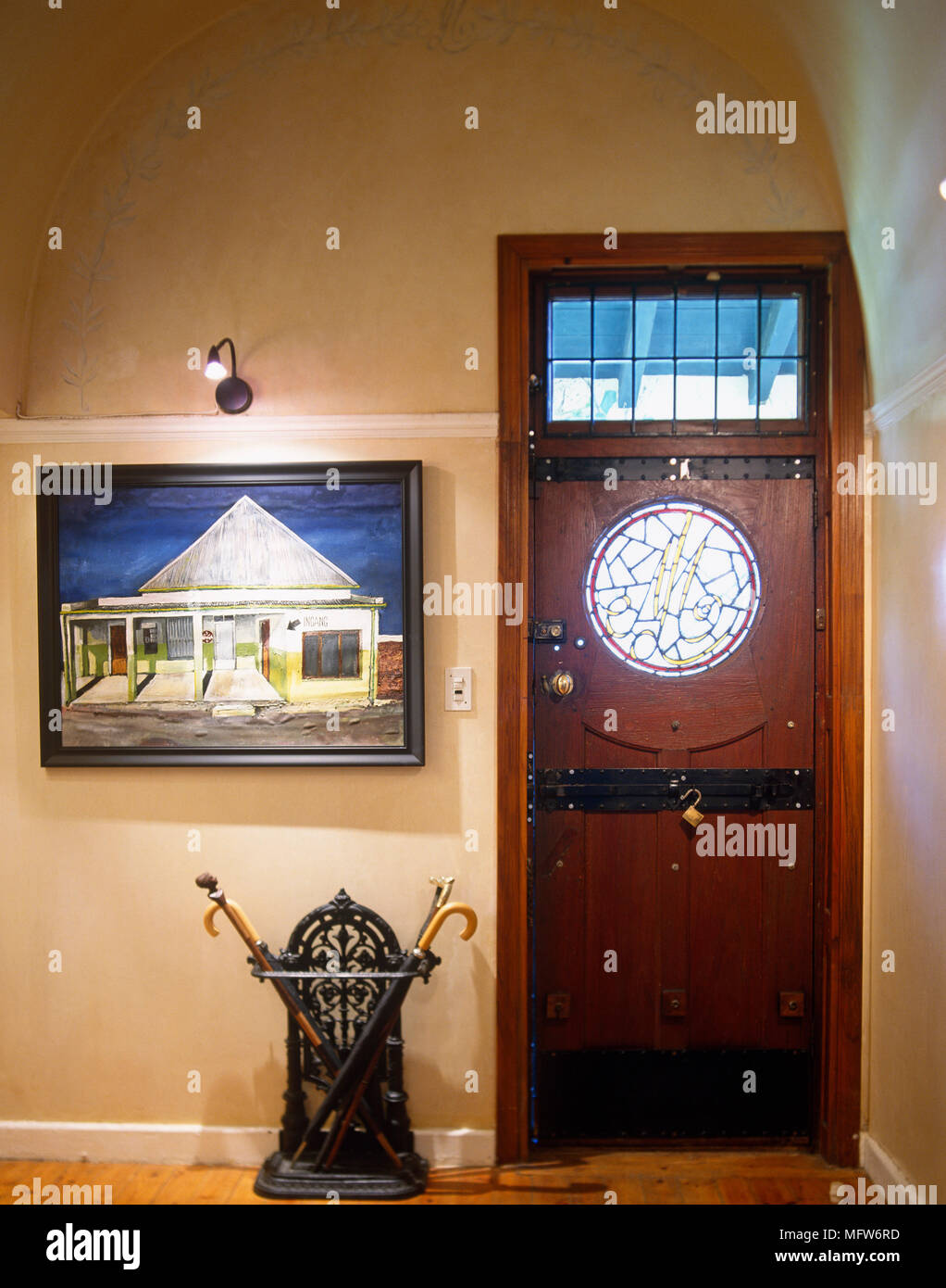 Wooden front door in yellow hallway Stock Photo - Alamy