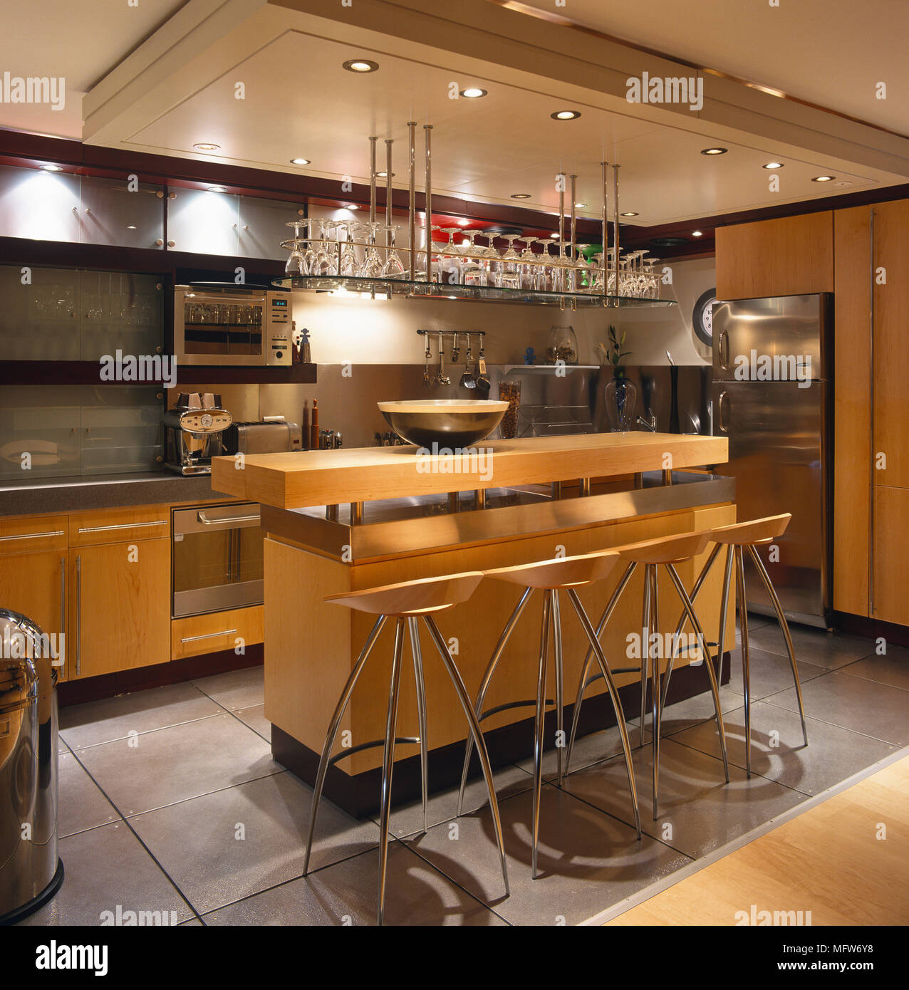 Four bar stools at breakfast bar island unit Stock Photo - Alamy