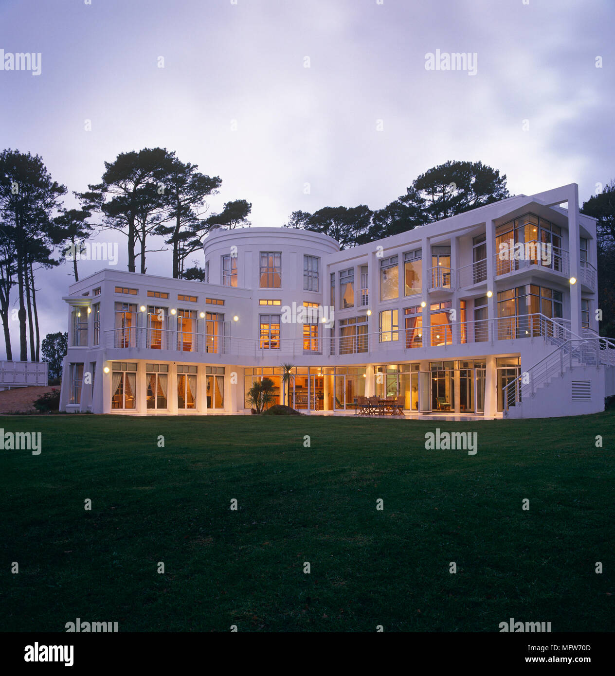 Lit exterior of large three storey mansion Stock Photo - Alamy