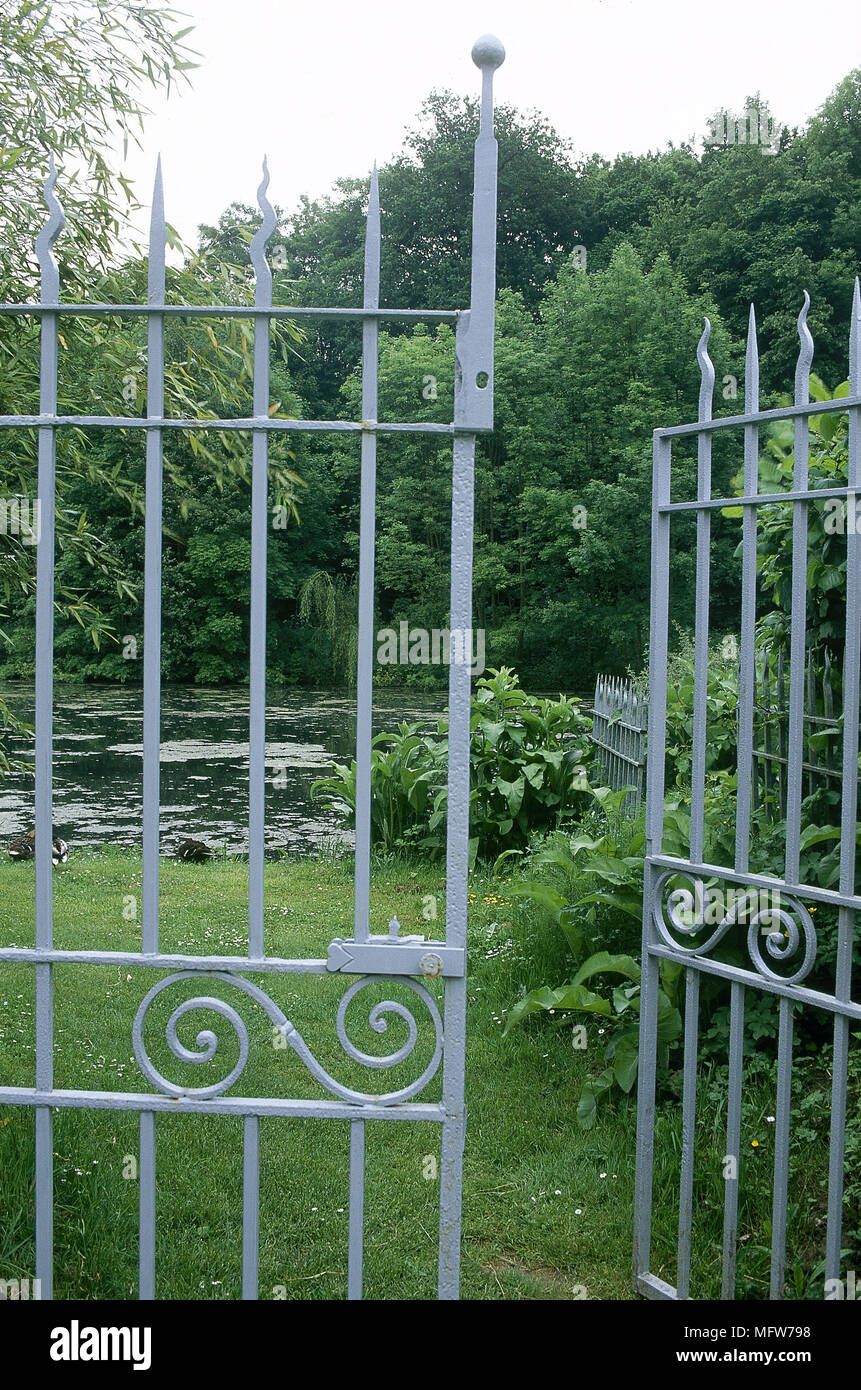Country garden ironwork gates pond gardens gates ponds Stock Photo - Alamy
