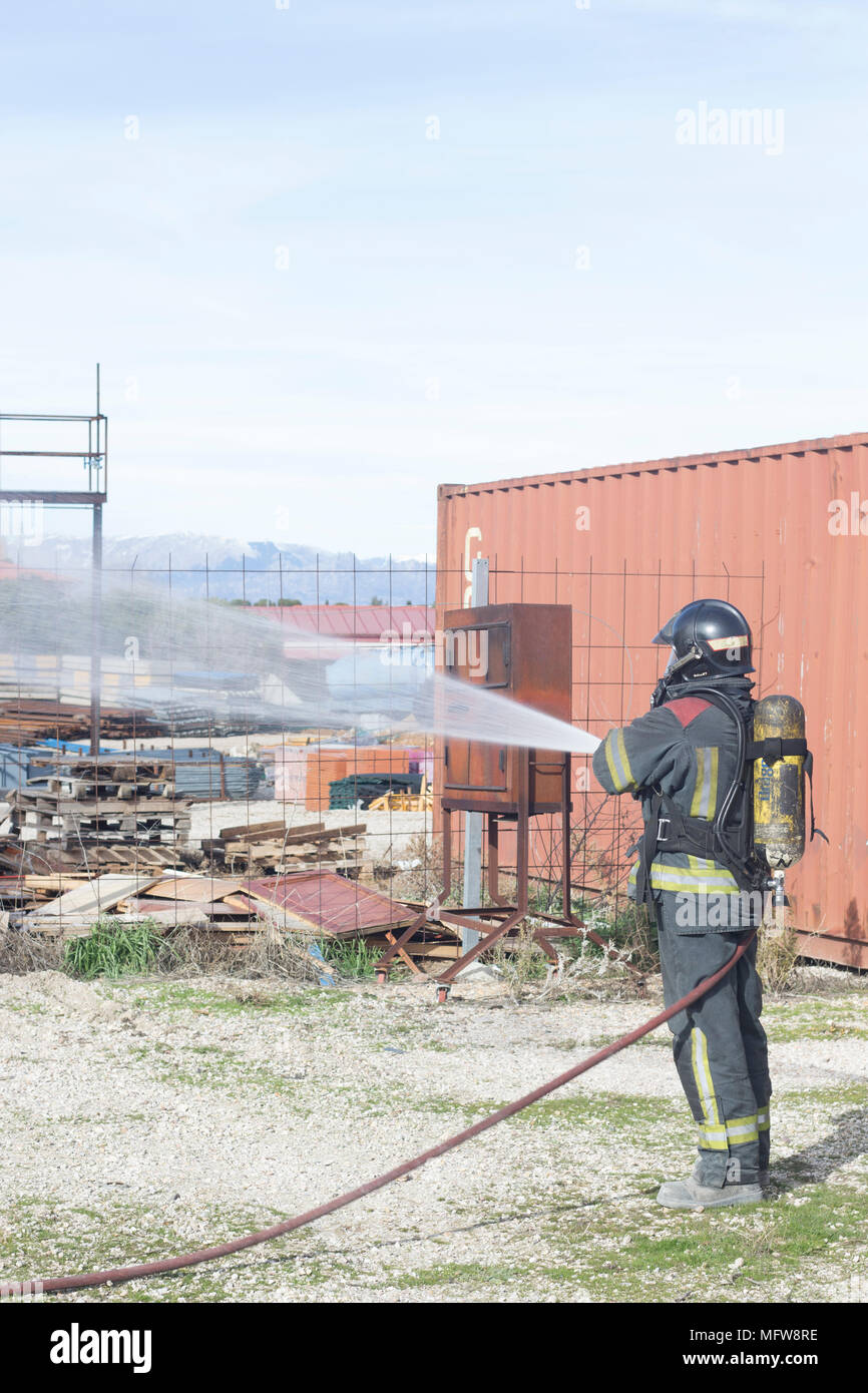 Firefighter putting out fire training station extinguisher backdraft ...