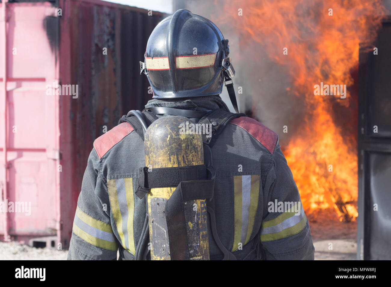 Firefighter putting out fire training station extinguisher backdraft ...