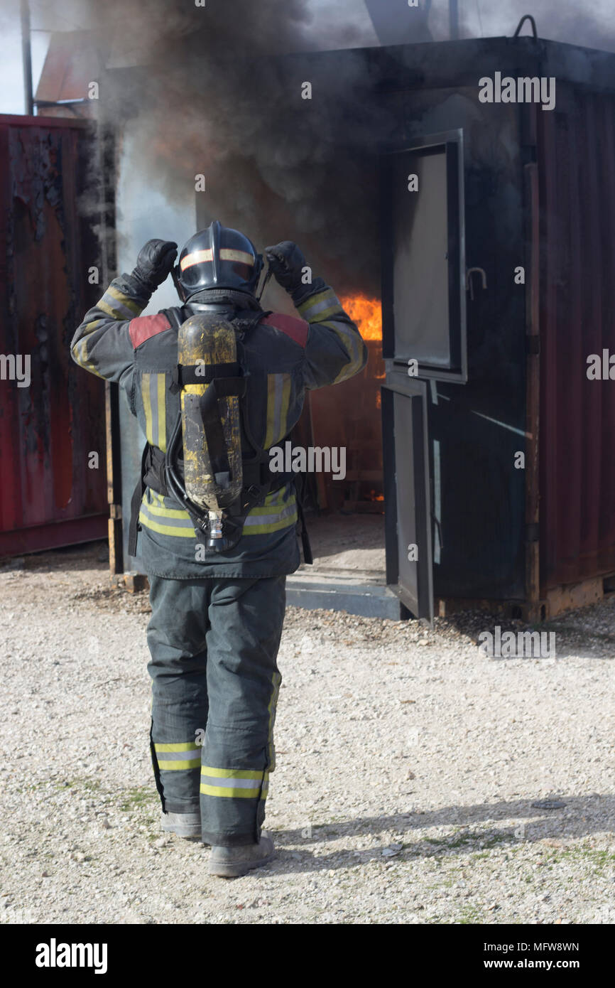 Firefighter putting out fire training station extinguisher backdraft ...
