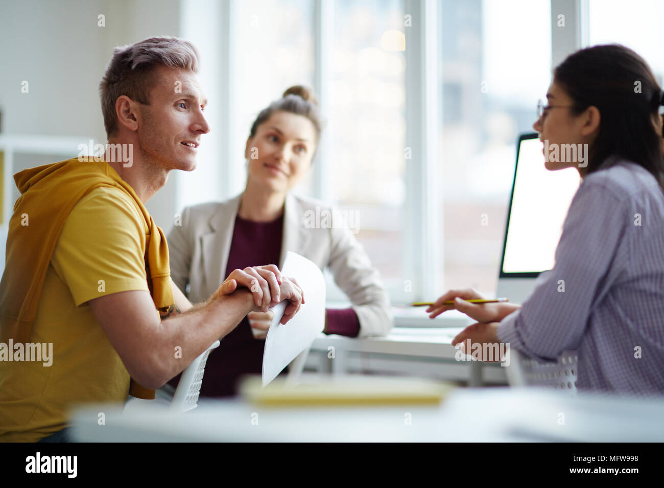 Group of designers sitting and discussing new plans at office Stock ...