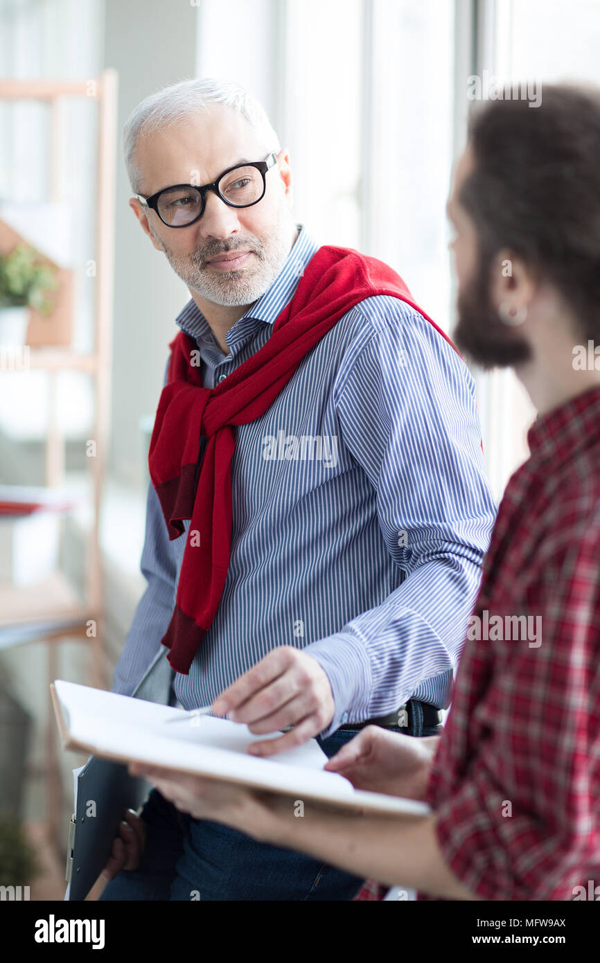 Mature leader giving an advice to young businessman Stock Photo - Alamy