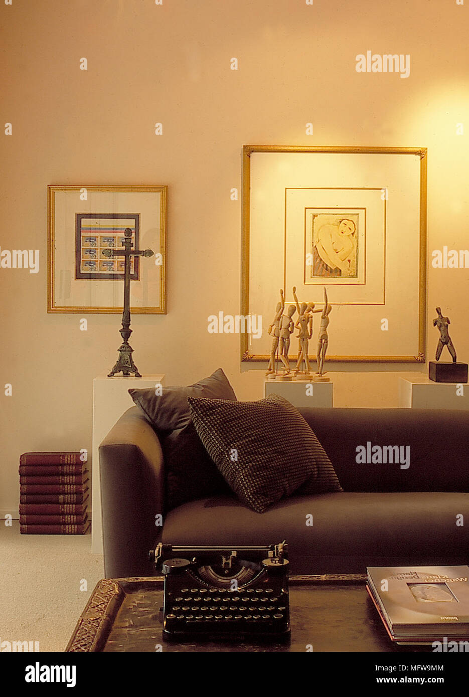 Wooden coffee table in front of upholstered sofa Stock Photo - Alamy