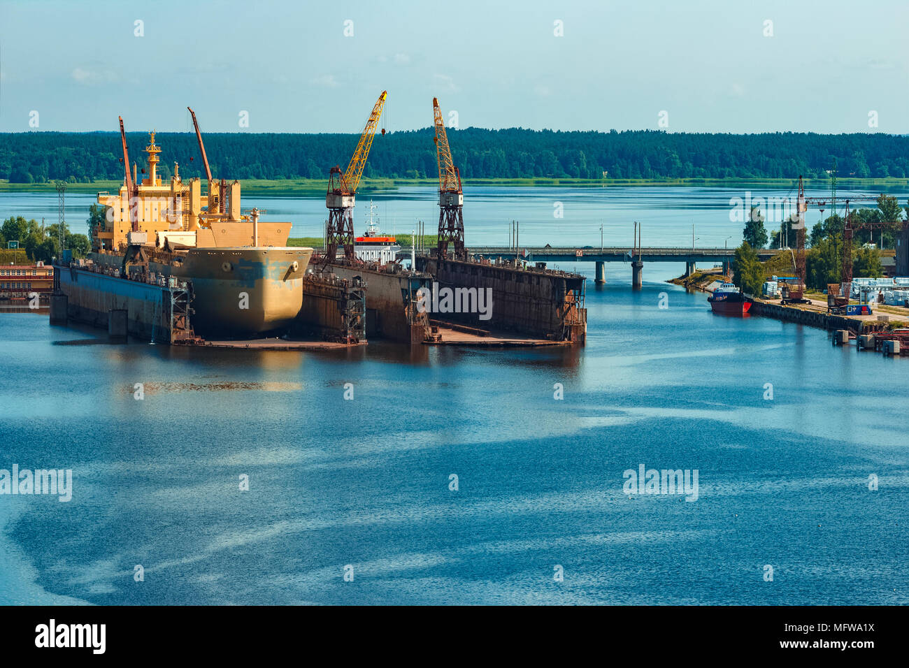 Yellow bulk carrier standing at the old shipyard in the dock Stock ...