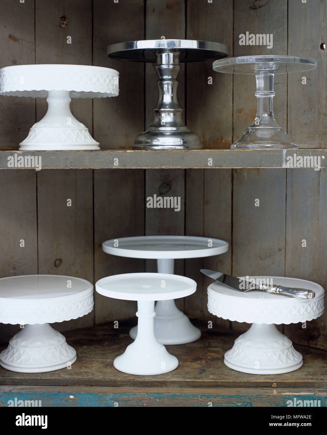 Collection of cake stands displayed in wooden shelves Stock Photo - Alamy