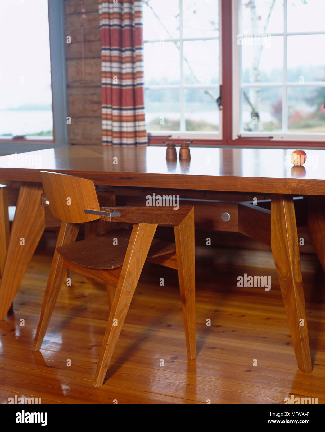 Contemporary wooden table and chairs in front of window Stock Photo - Alamy