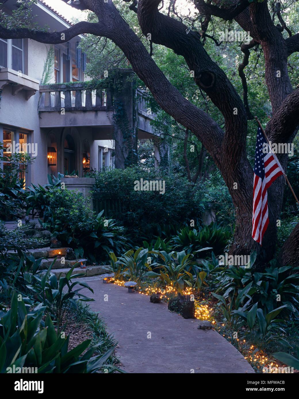 Exterior of country style house with path lined with lit candles at ...