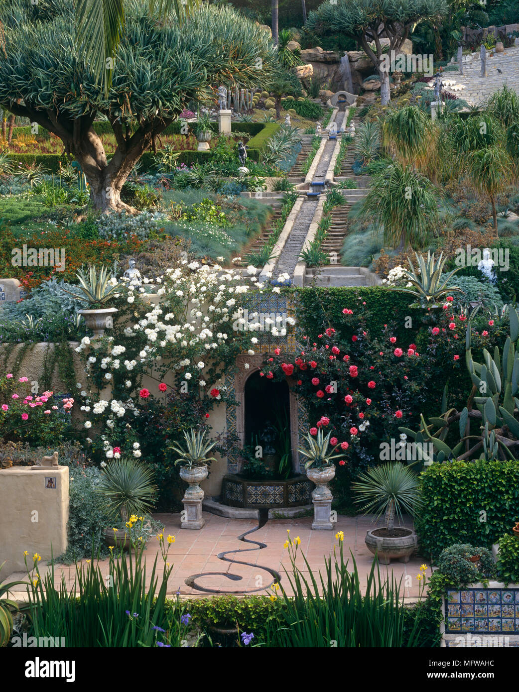 Formal terraced garden with steps leading up side of hill Stock Photo ...