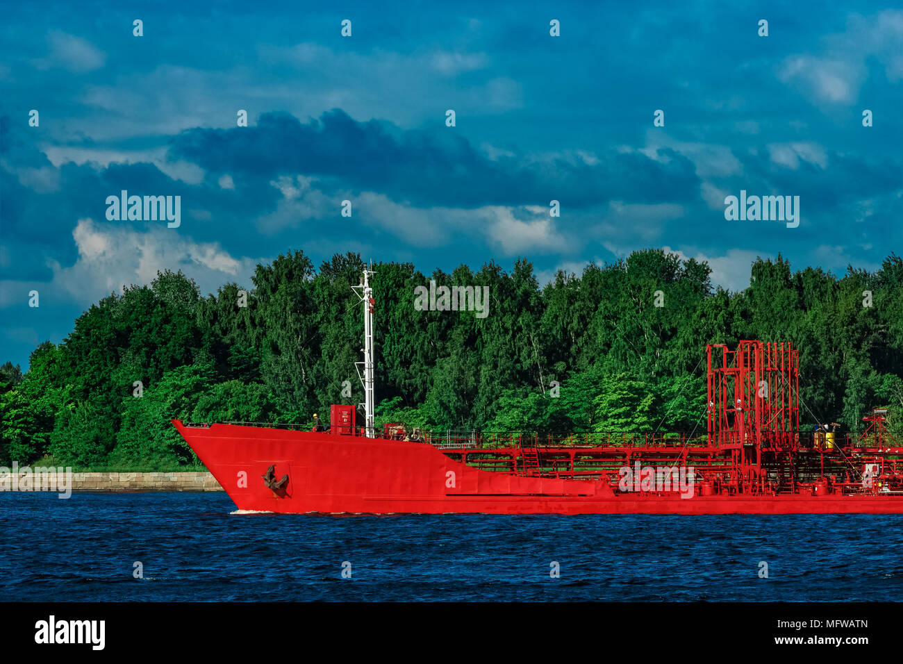 Red cargo tanker ship moving by the river Stock Photo - Alamy