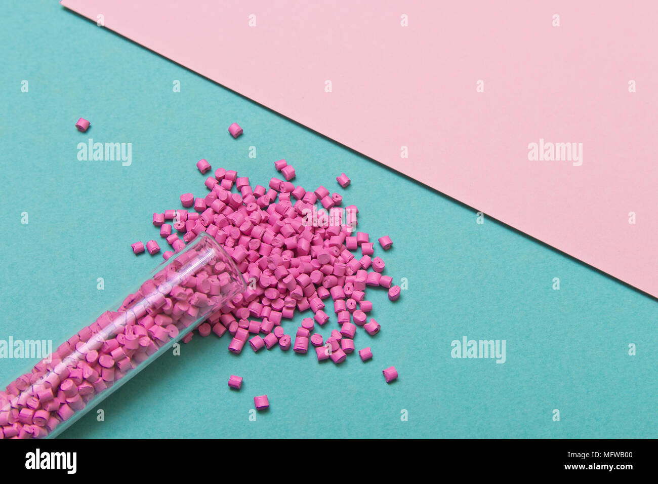 Plastic pellets. Pink Plastic granules on a geometric background ...