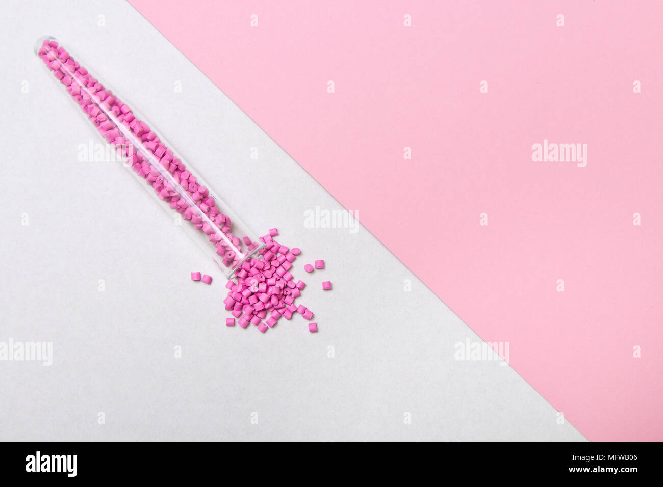 Plastic pellets. Pink Plastic granules on a geometric background ...