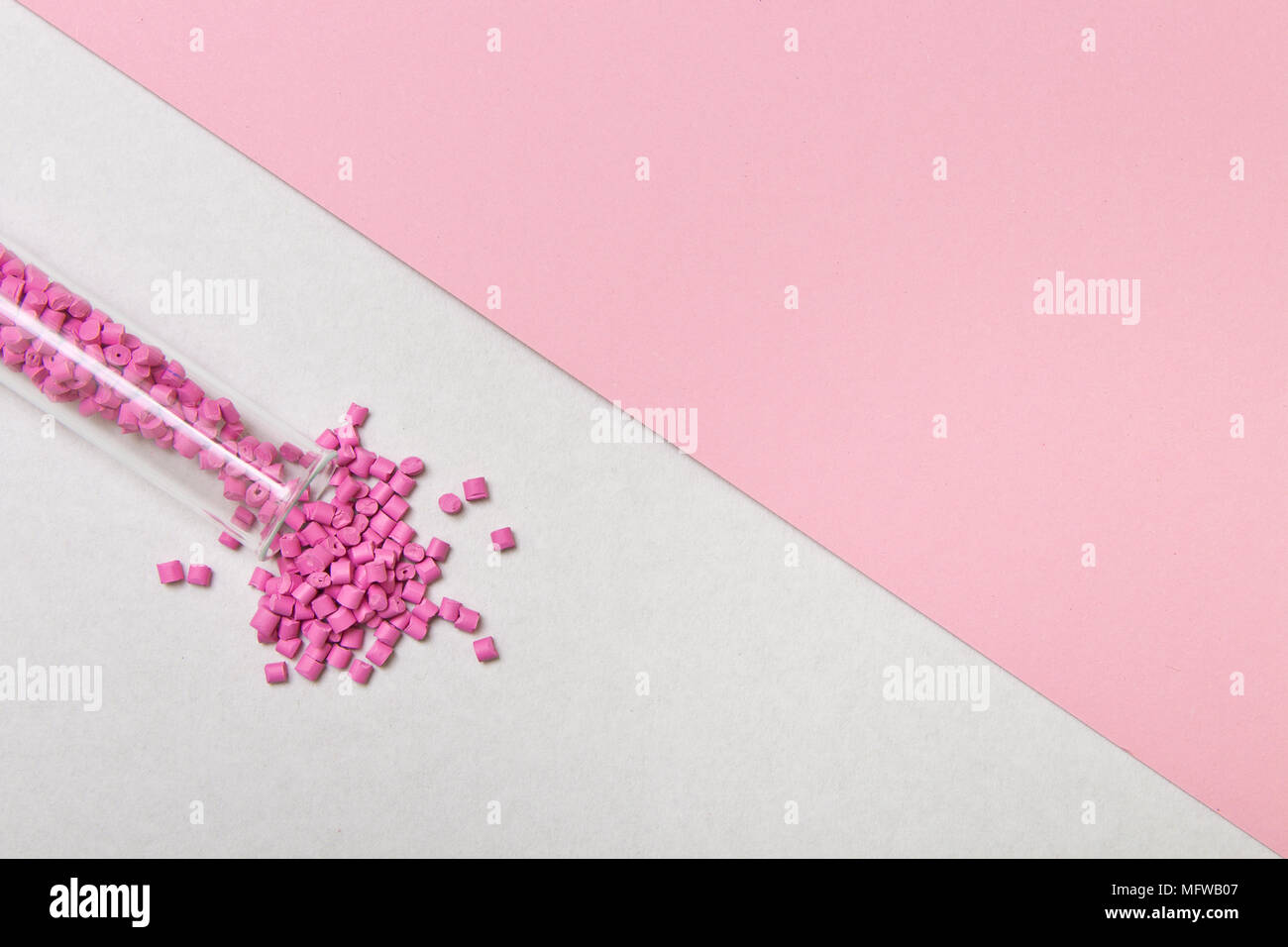 Plastic pellets. Pink Plastic granules on a geometric background ...